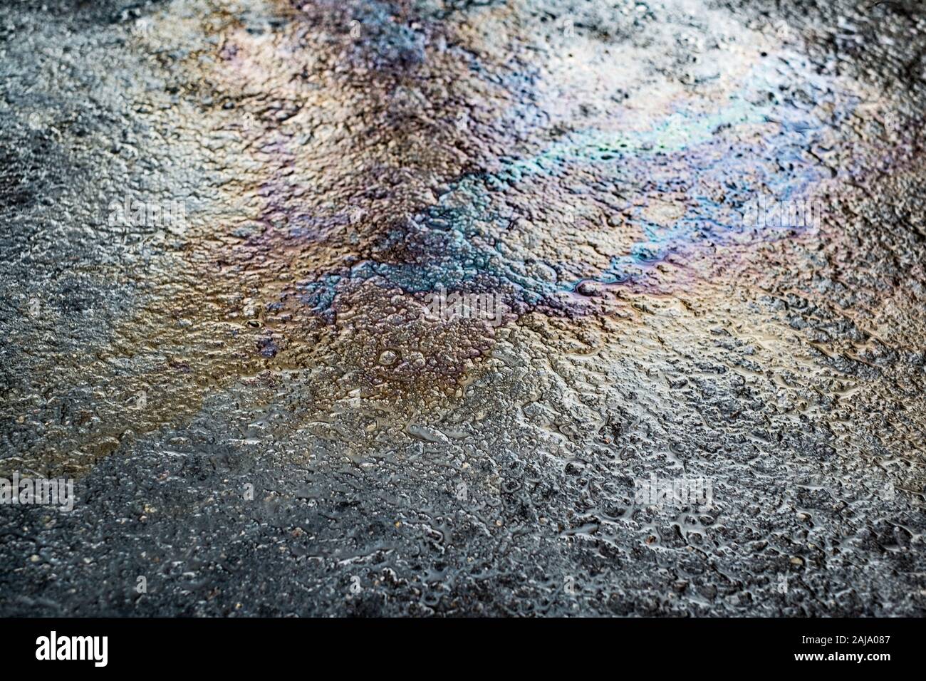 Oil stain on Asphalt road after rain, color Gasoline fuel spots on ...