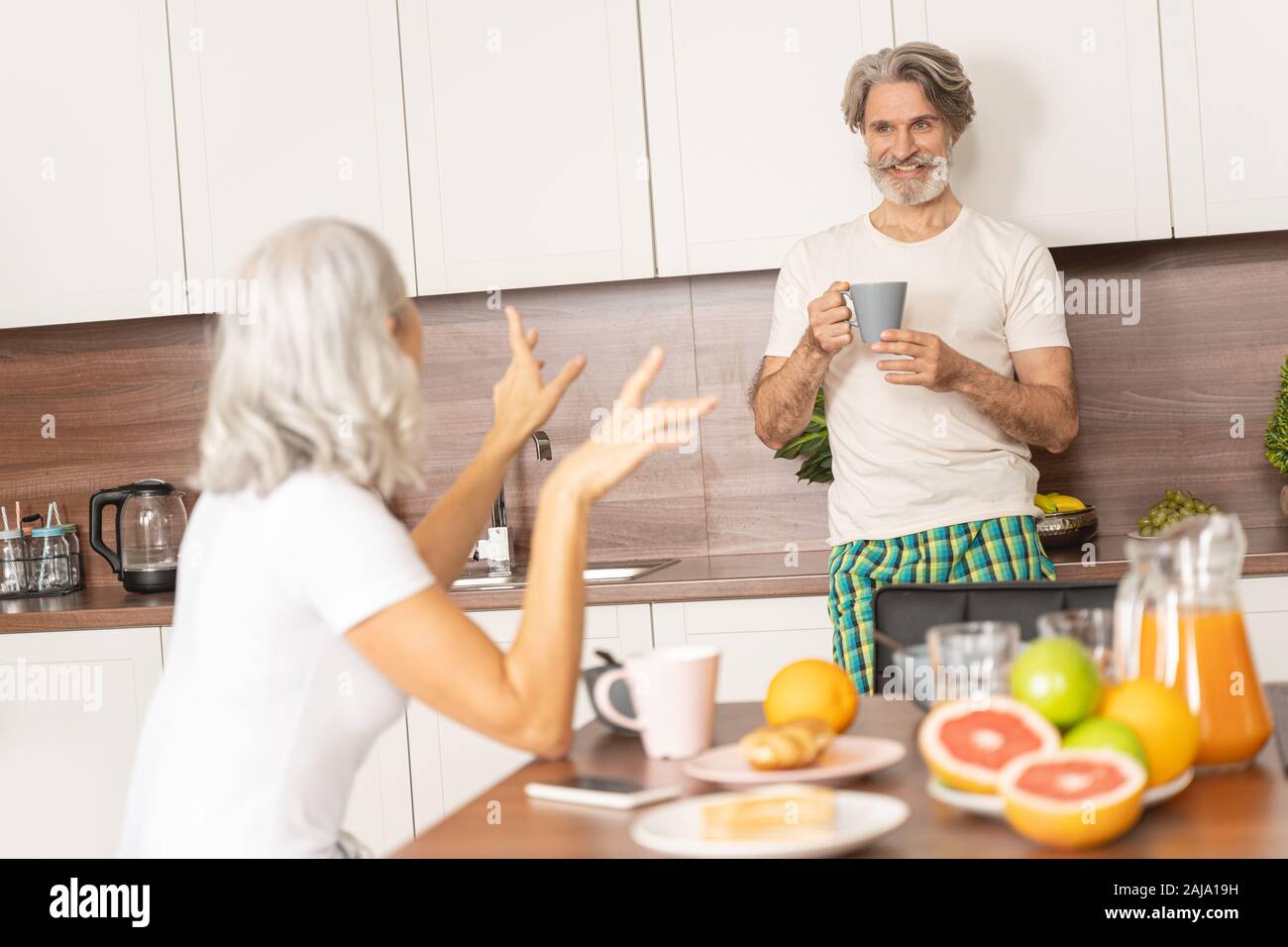 Aged husband tea listening wife hi-res stock photography and images - Alamy