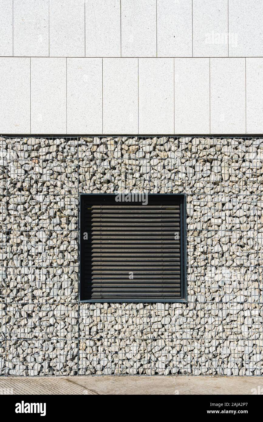 Window built on a caged stone wall in a modern building Stock Photo - Alamy