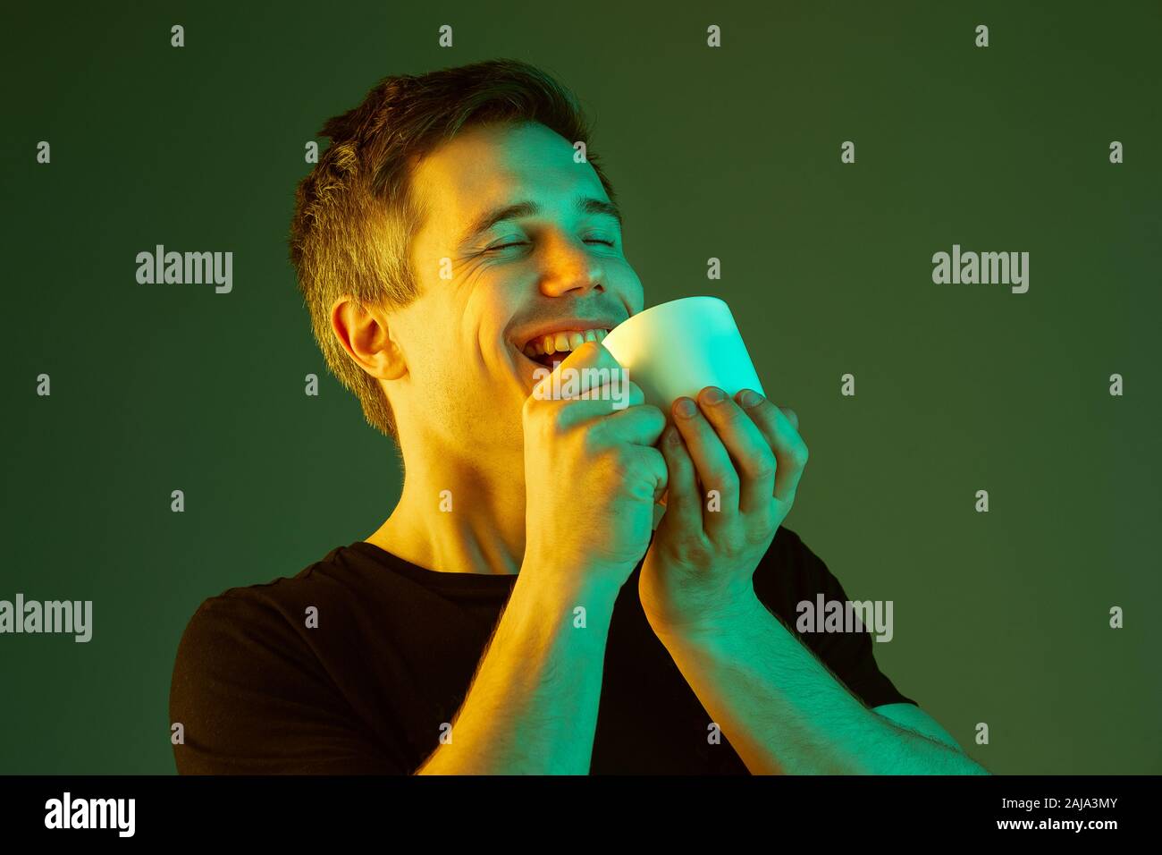 Drinking tea, coffee, smiling. Caucasian man's portrait isolated on ...