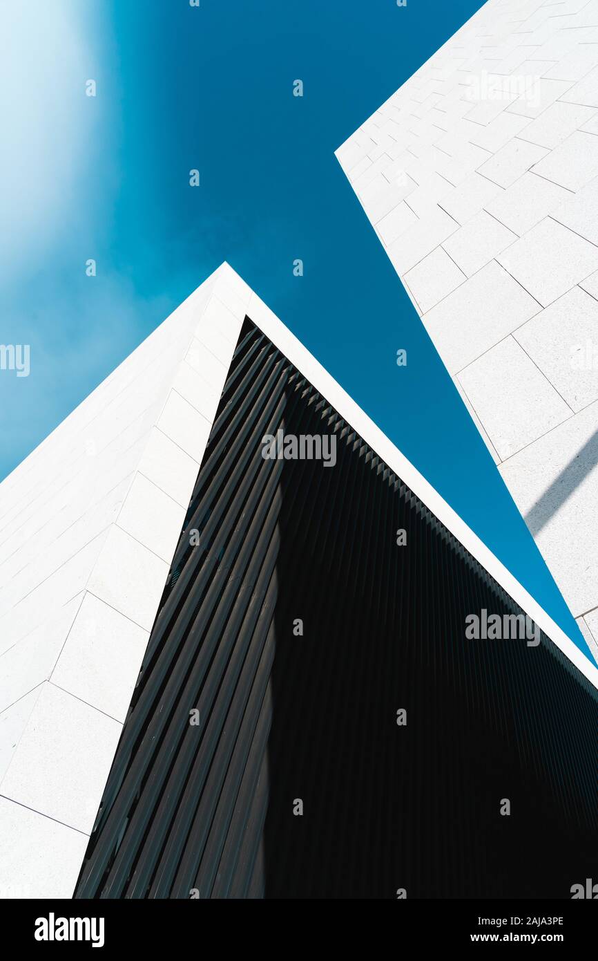 Corners of two contiguous buildings of modern architecture looking up ...