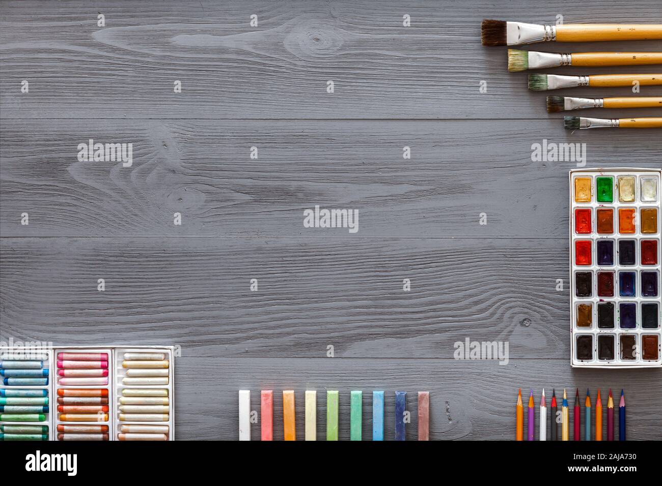 Art creative table background with supplies tools on grey wooden desk ...