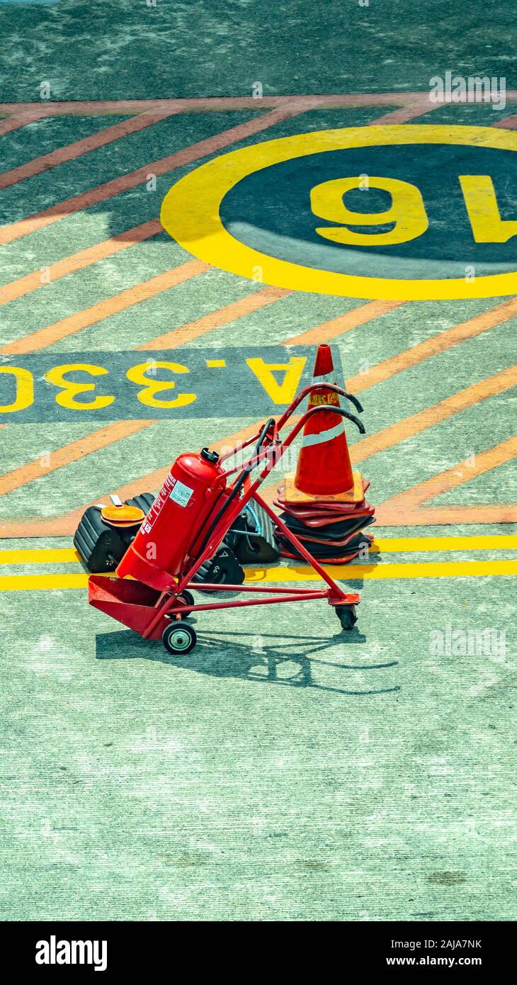 fire extinguisher and traffic cone in the runway. aviation equipment ...