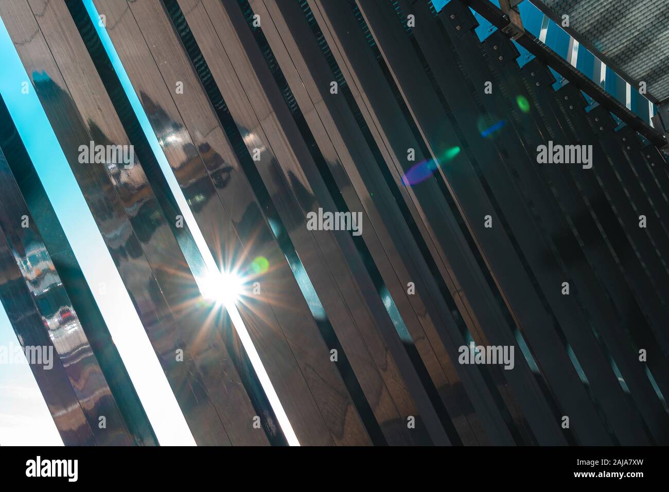 Reflections of the sun entering a corridor of a modern architecture ...
