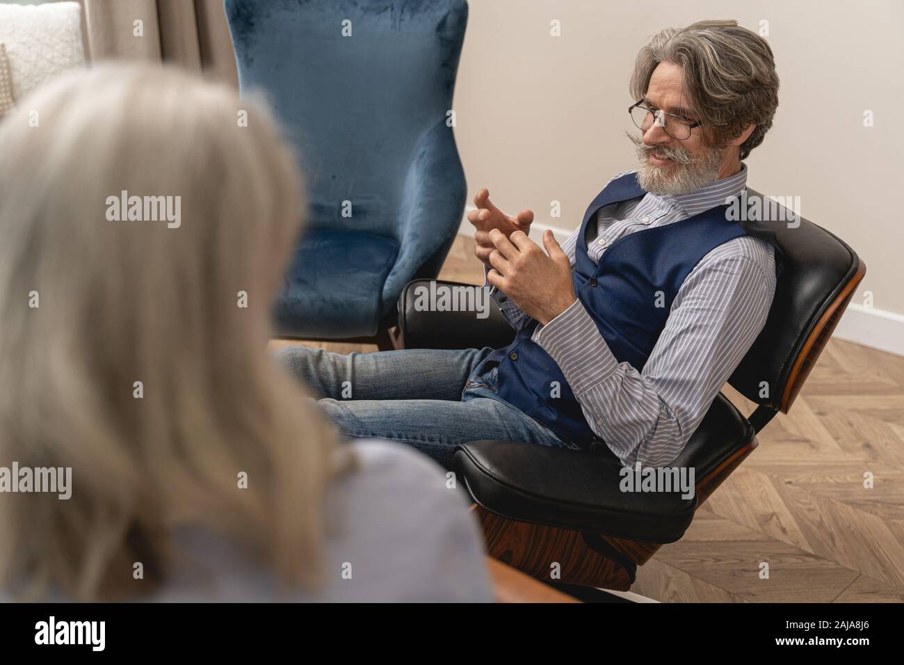 Handsome businessman smiling at his female psychologist Stock Photo - Alamy