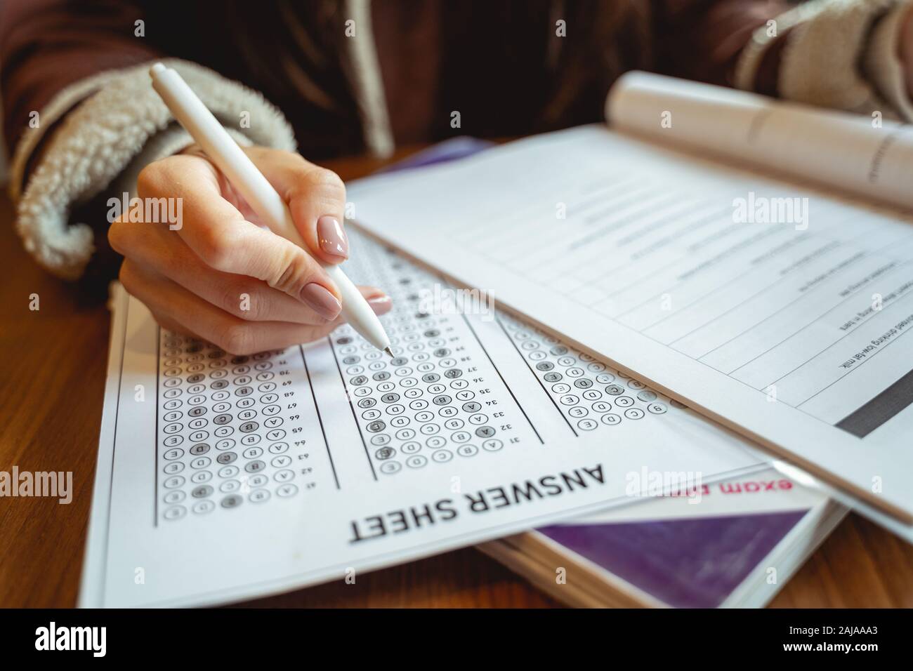 Young female person completing task before exams Stock Photo - Alamy