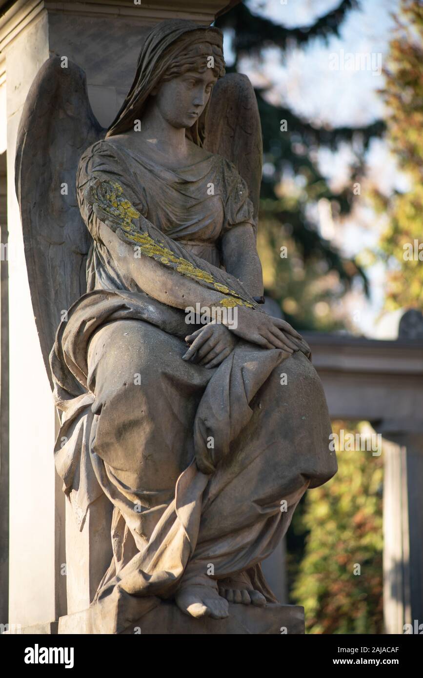 Detailed stone statue of an angel on a german graveyard in Berlin on a ...