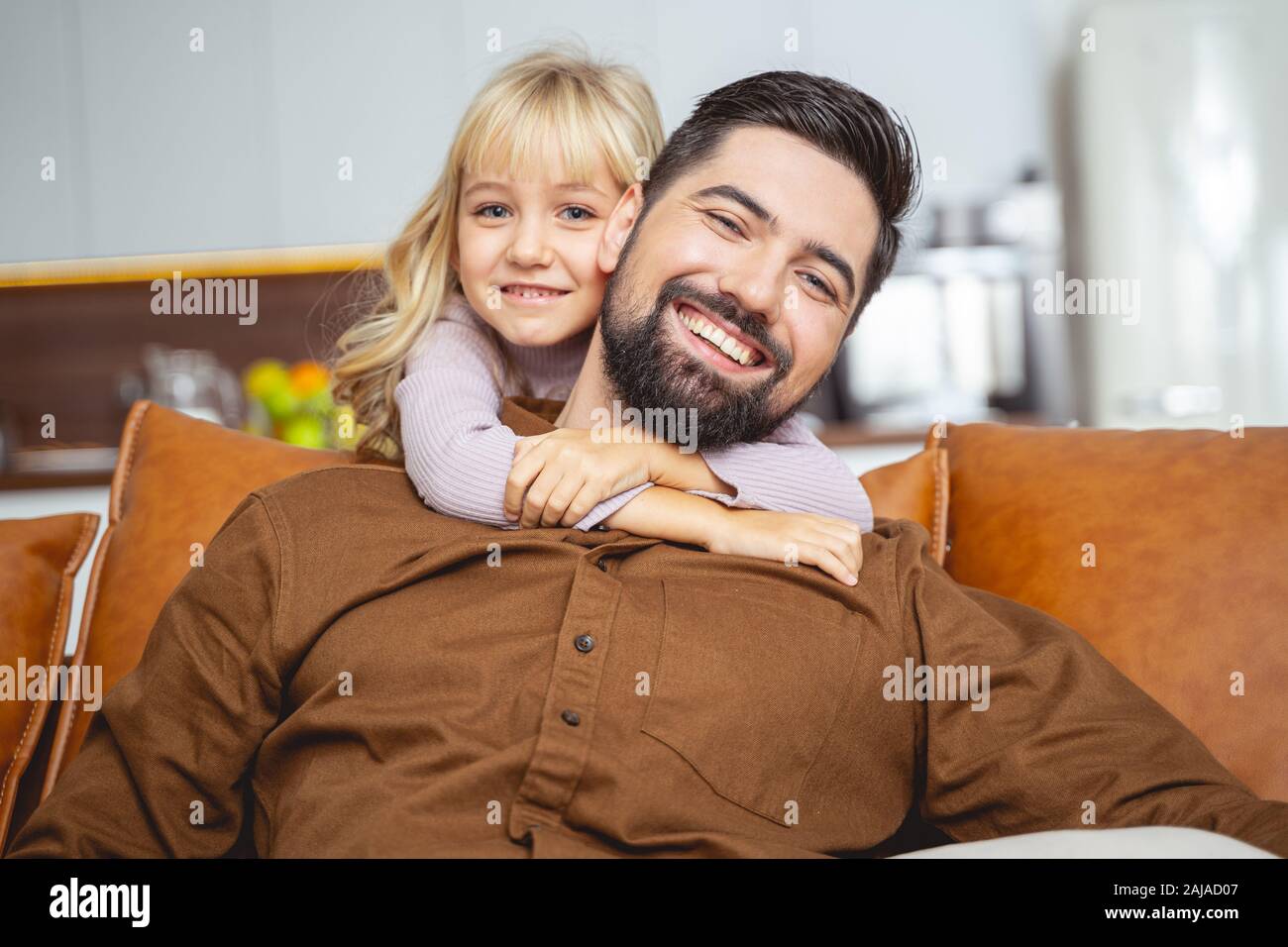 Adorable little girl hugging father from behind Stock Photo - Alamy