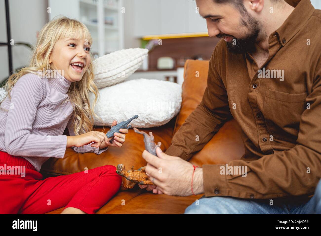 Cheerful father and daughter playing with toys Stock Photo - Alamy