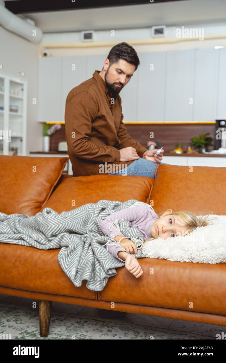 Worried father looking at his sick daughter Stock Photo - Alamy