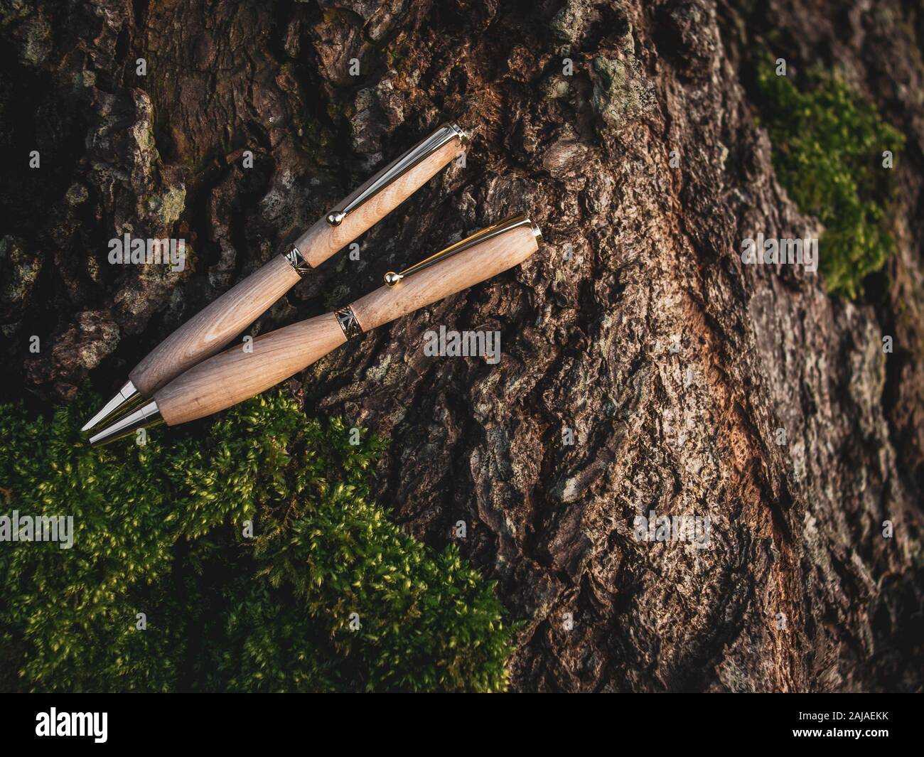 Eco friendly wooden pen, made out of recycled wood and brass, outside ...