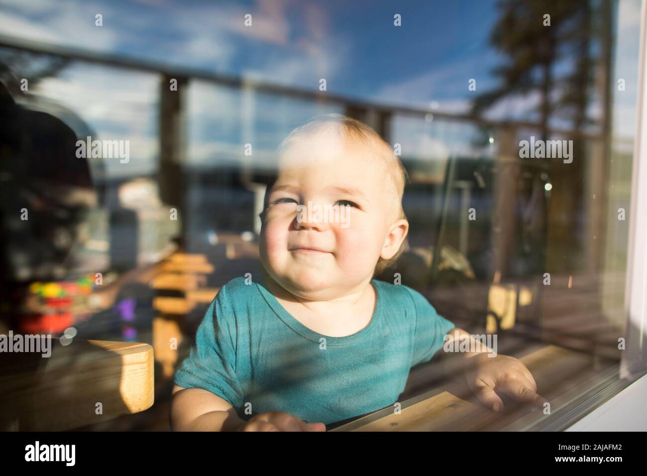 Portrait of young girl looking out through cabin window Stock Photo - Alamy