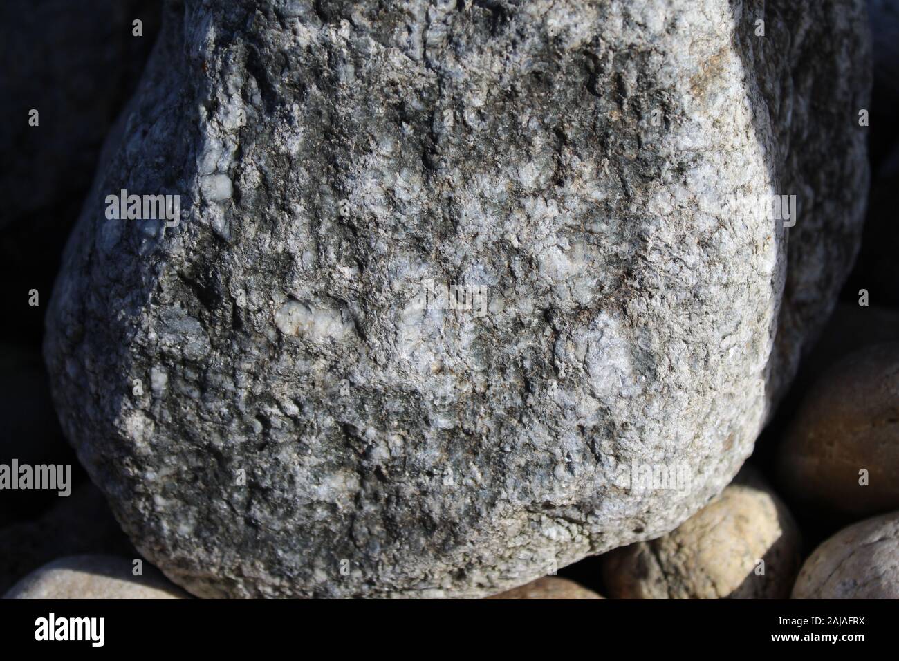The picture shows a big stone and little stones Stock Photo - Alamy
