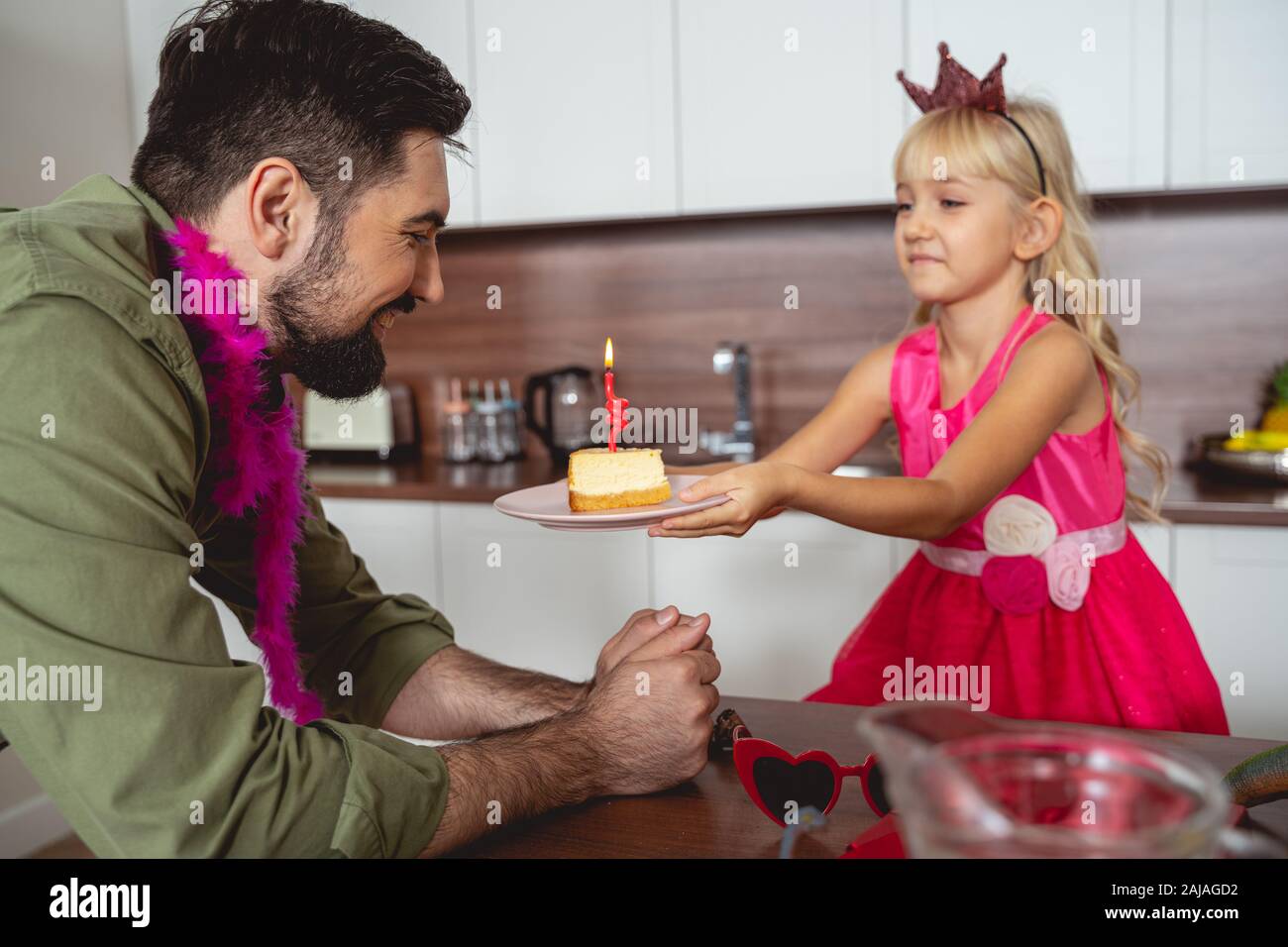 Smiling little girl giving cake to father Stock Photo - Alamy