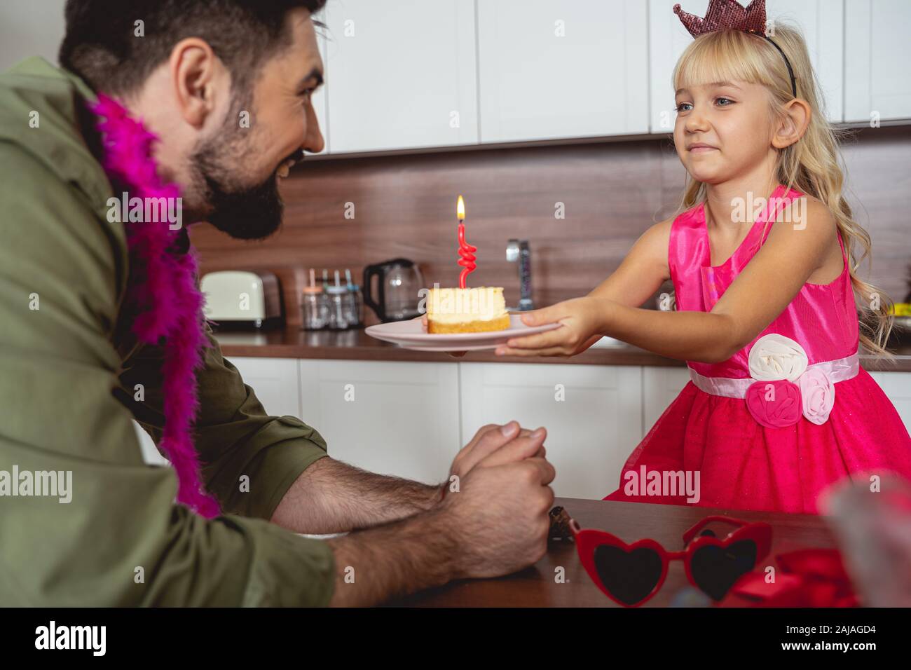 Cute little girl giving cake to father Stock Photo - Alamy