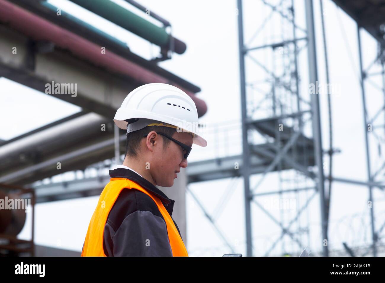 worker outside in front of pipes Stock Photo - Alamy