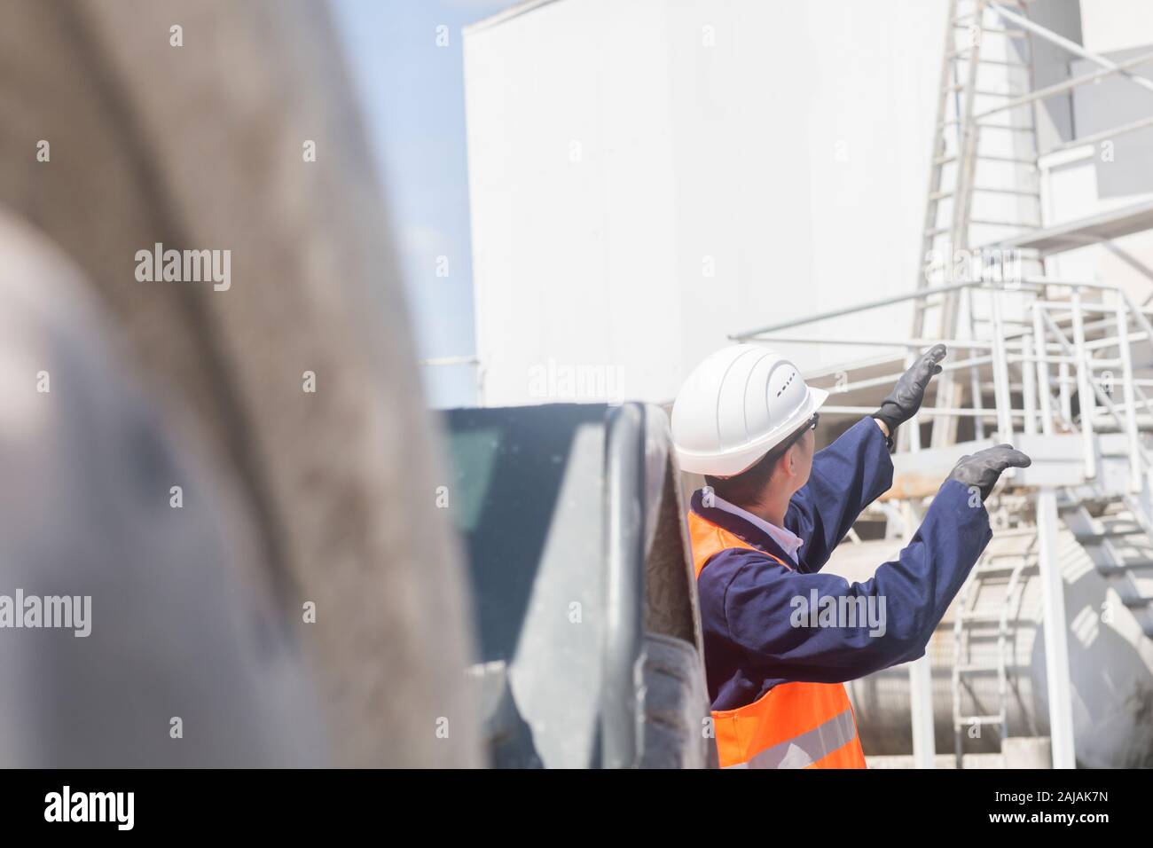 concrete worker waving with arms in a concrete factory Stock Photo - Alamy