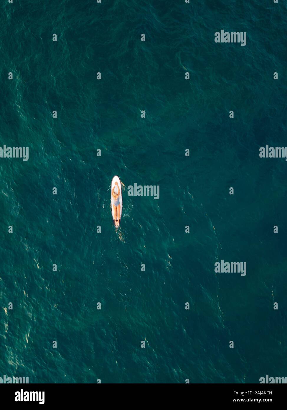 Aerial view of female surfer Stock Photo - Alamy