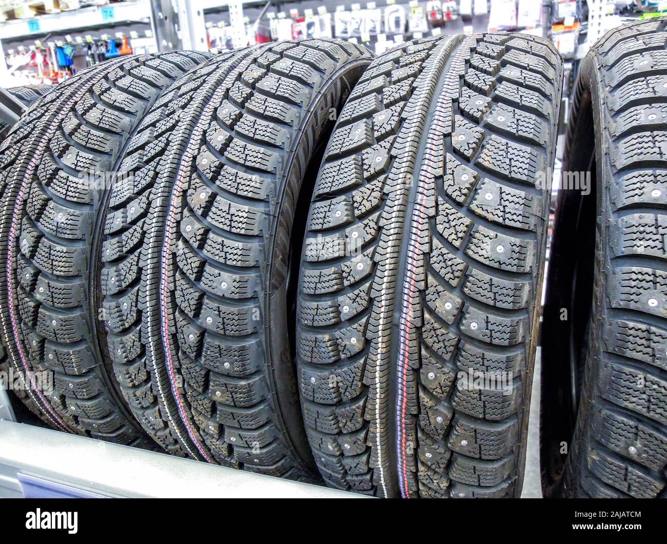 Winter vehicle tires stacked up for sale in the chain hypermarket. New ...