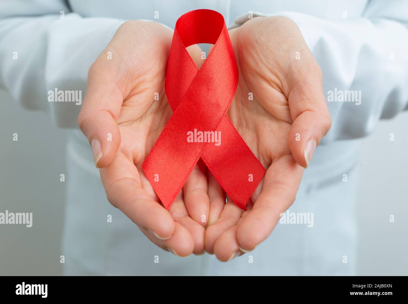 The red ribbon is a symbol of the fight against AIDS Stock Photo - Alamy