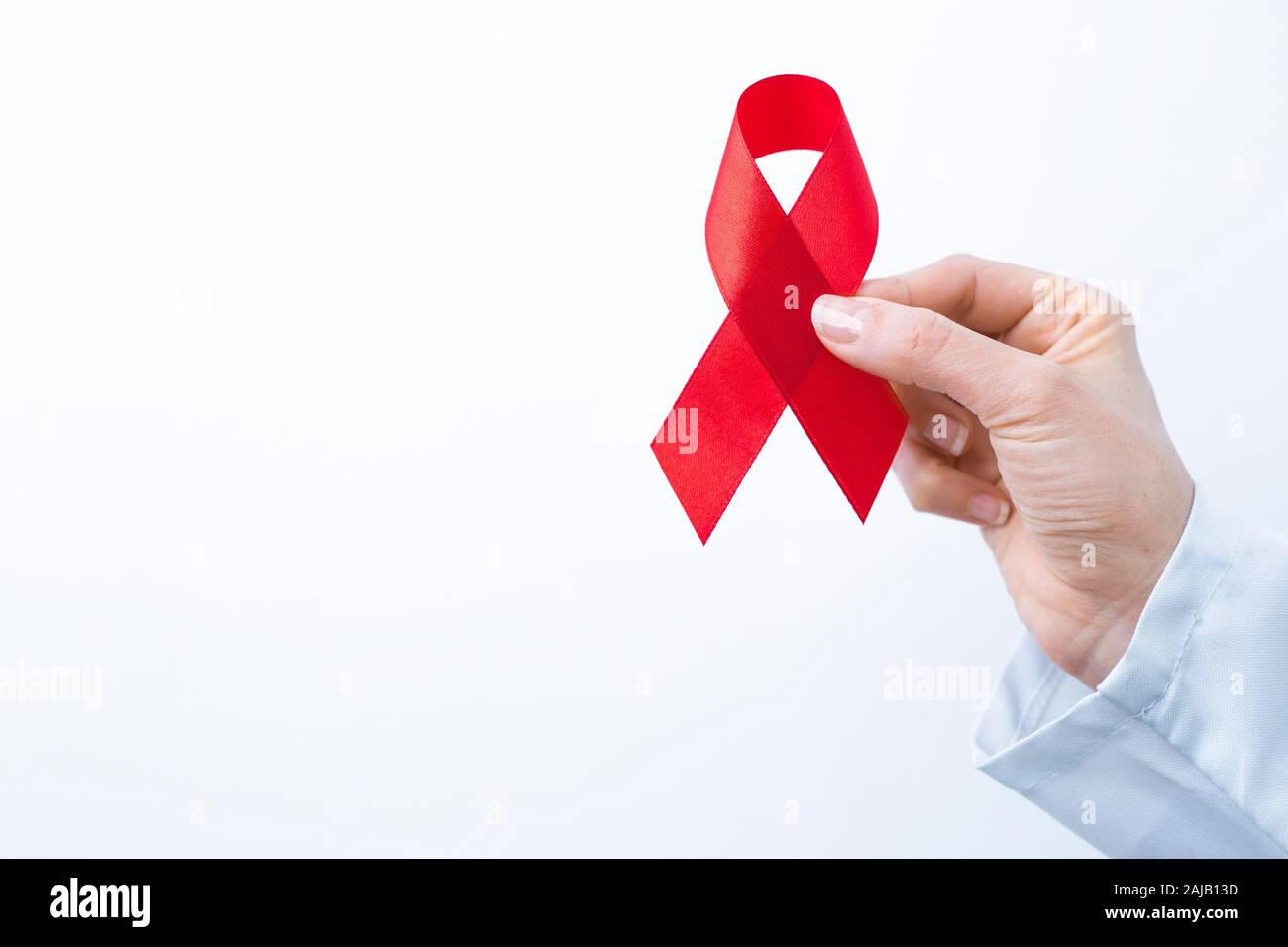 The red ribbon is a symbol of the fight against AIDS Stock Photo - Alamy