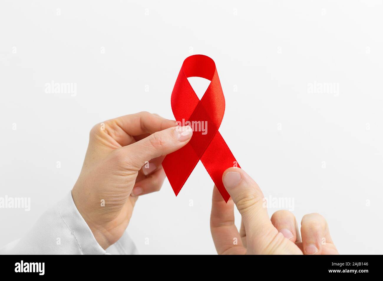 The red ribbon is a symbol of the fight against AIDS Stock Photo - Alamy