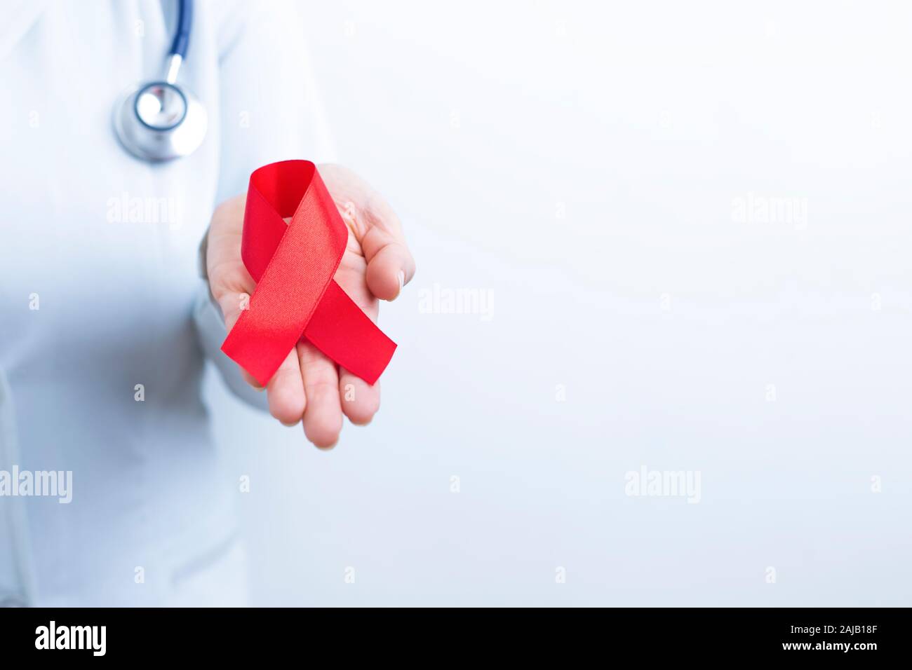 The red ribbon is a symbol of the fight against AIDS Stock Photo - Alamy