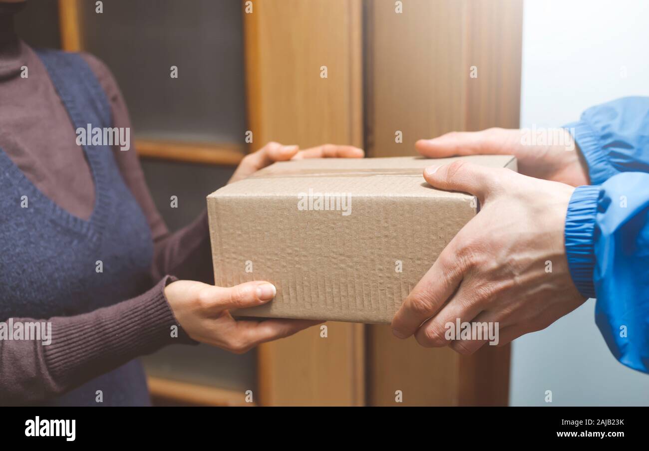 The courier gives delivery boxes to the customer Stock Photo - Alamy