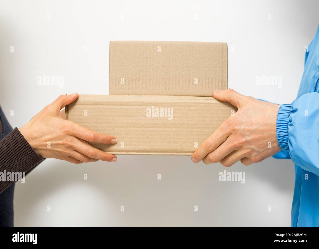 The courier gives delivery boxes to the customer Stock Photo - Alamy