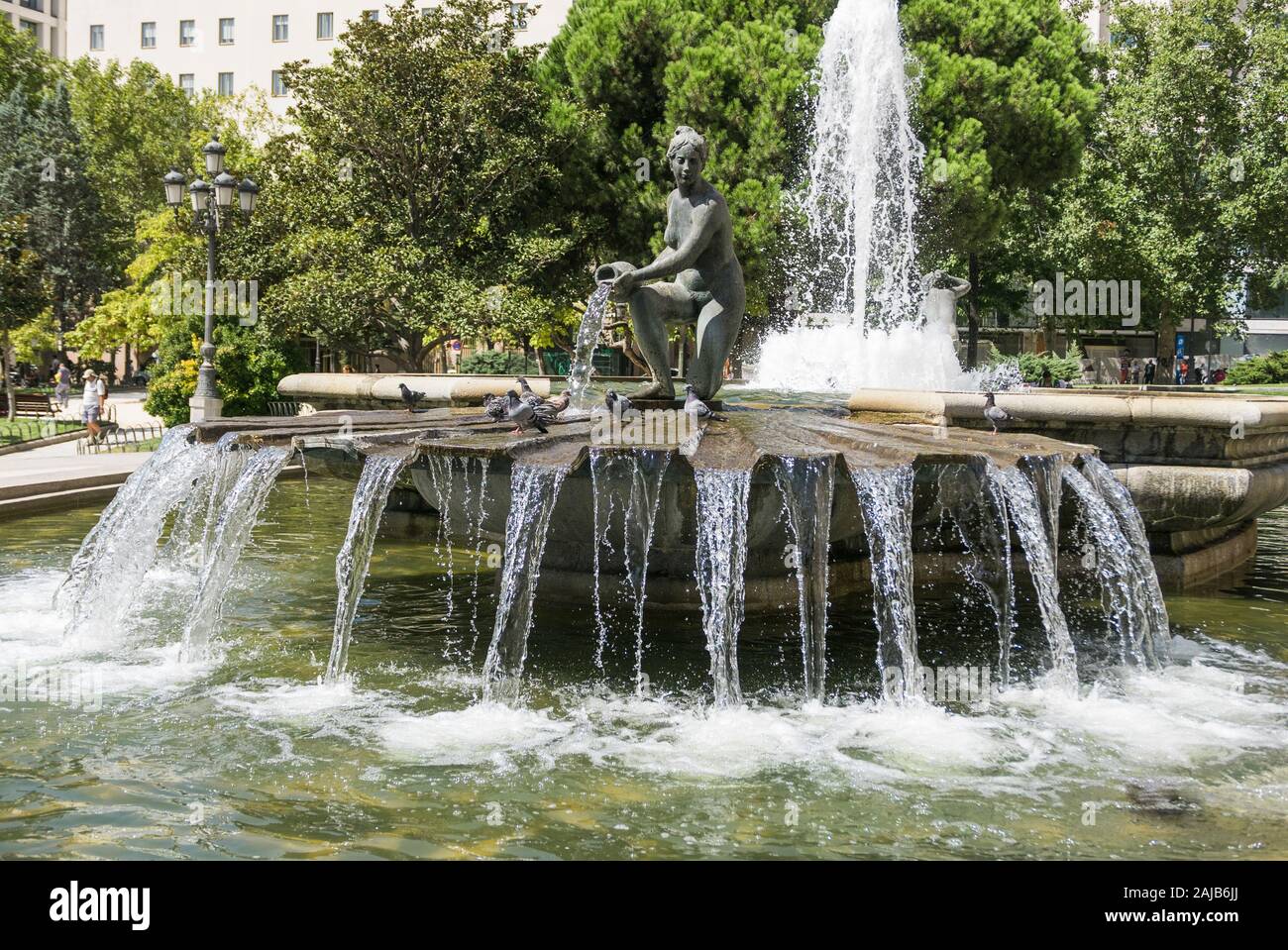 Water fountain with sculpture of woman pouring water from pot hi-res ...