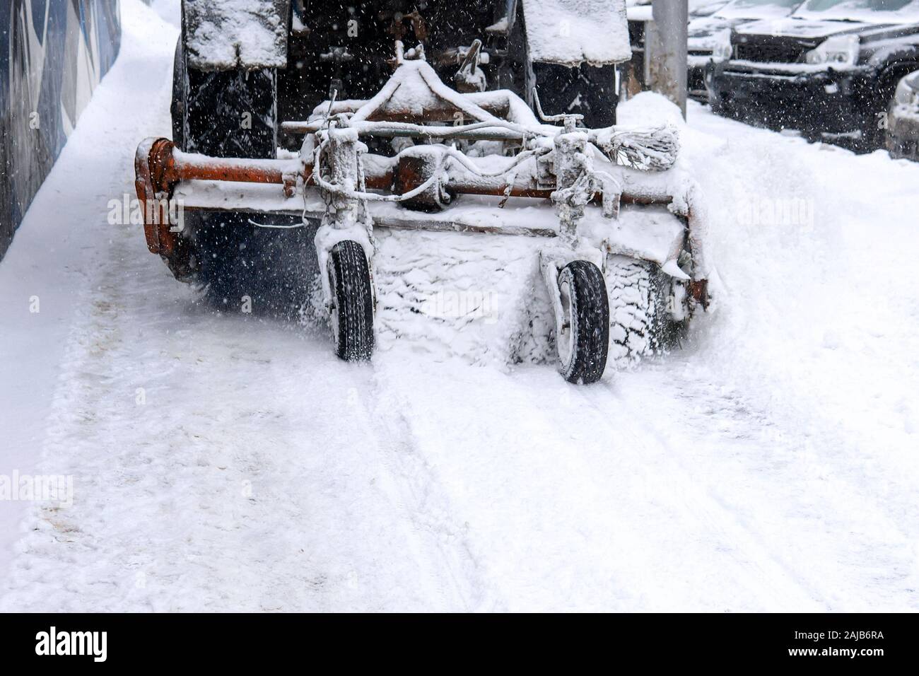 mechanical street sweeper brush trying to sweep snow off the sidewalk ...