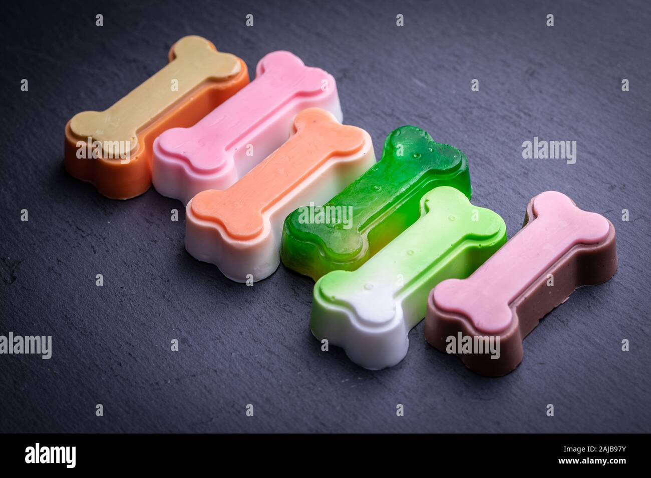 Cute colored bones on dark dark background Stock Photo - Alamy