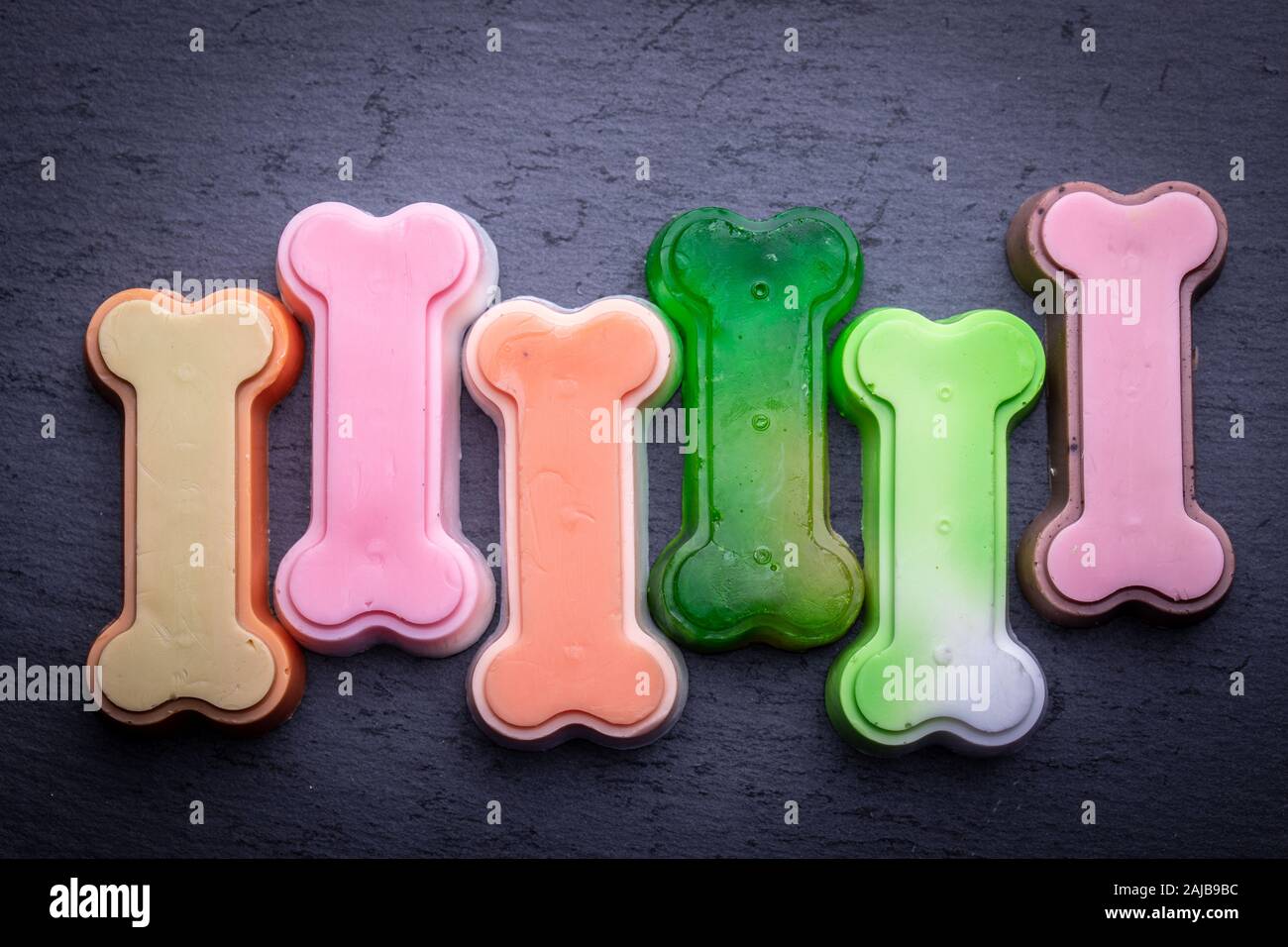 Cute colored bones on dark dark background Stock Photo - Alamy