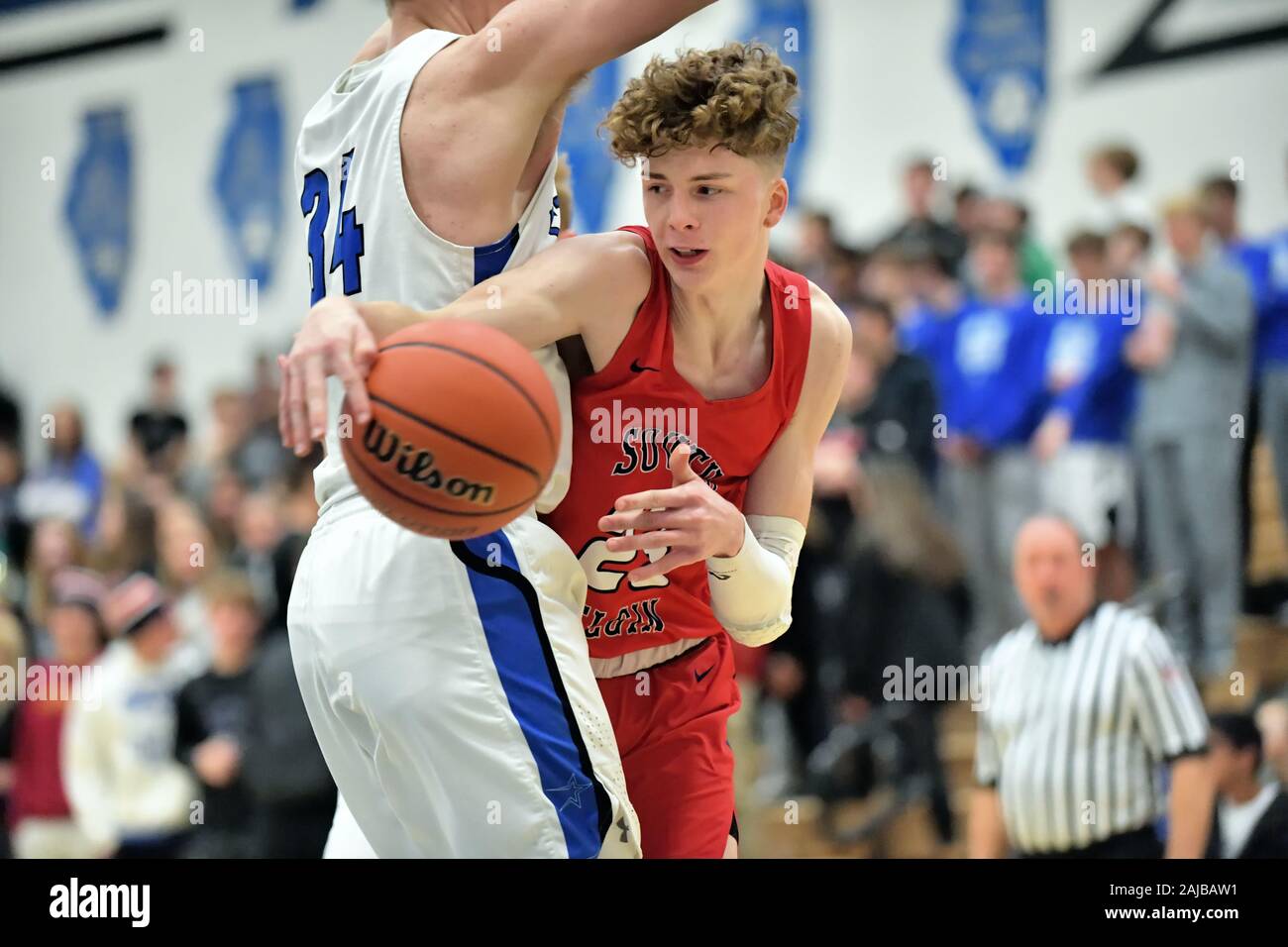 Player attempting to maintain control of the ball under the basket ...