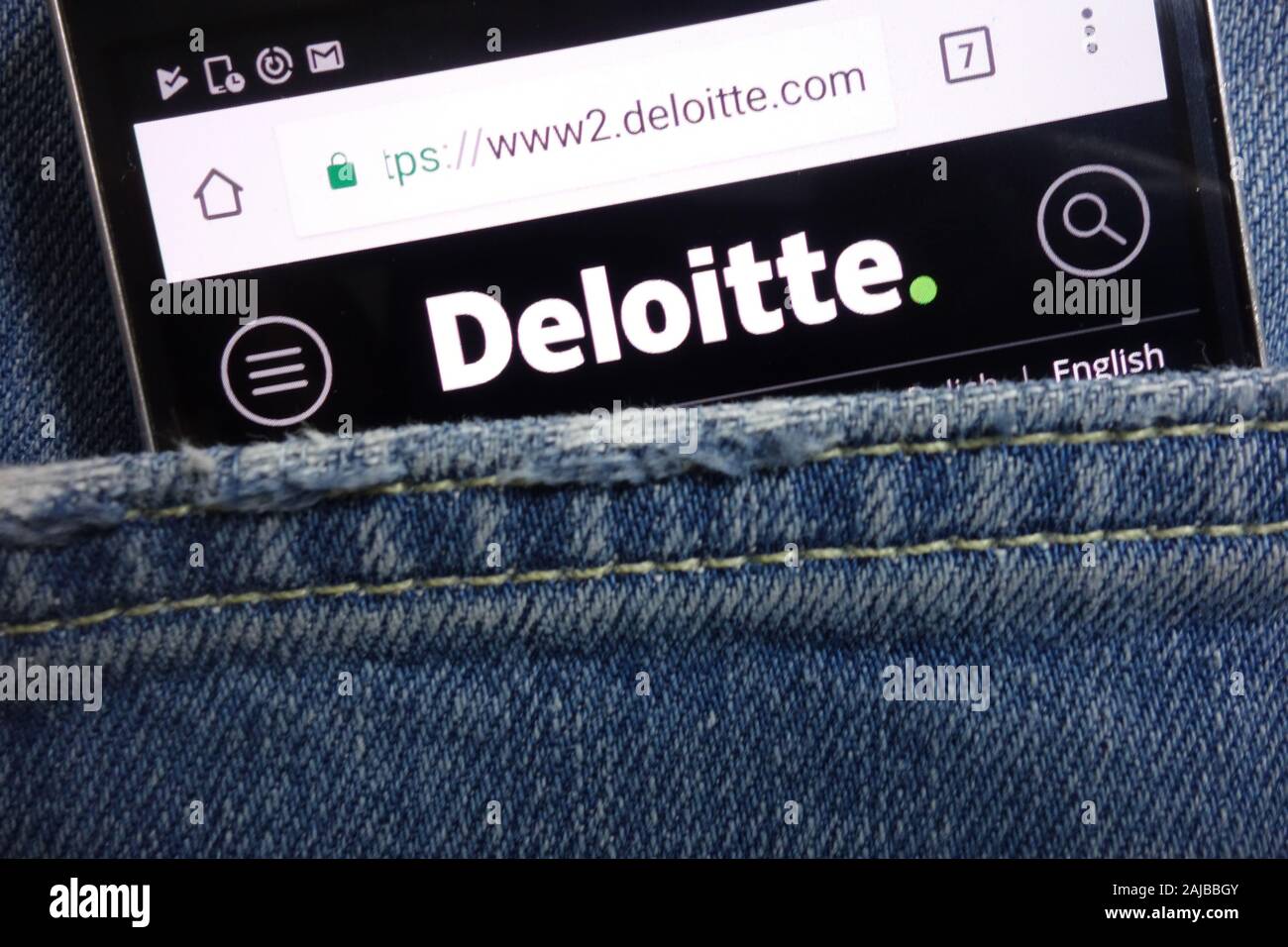 Deloitte website displayed on smartphone hidden in jeans pocket Stock ...