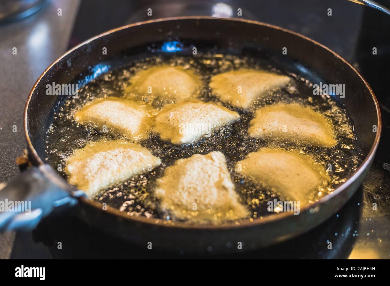 fried portuguese or brazilian rissoles in a pan in a kitchen Stock ...