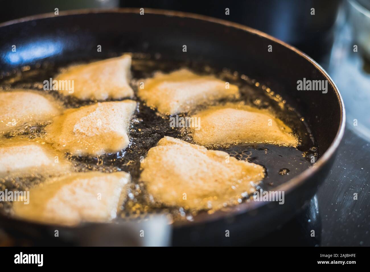 fried portuguese or brazilian rissoles in a pan in a kitchen Stock ...
