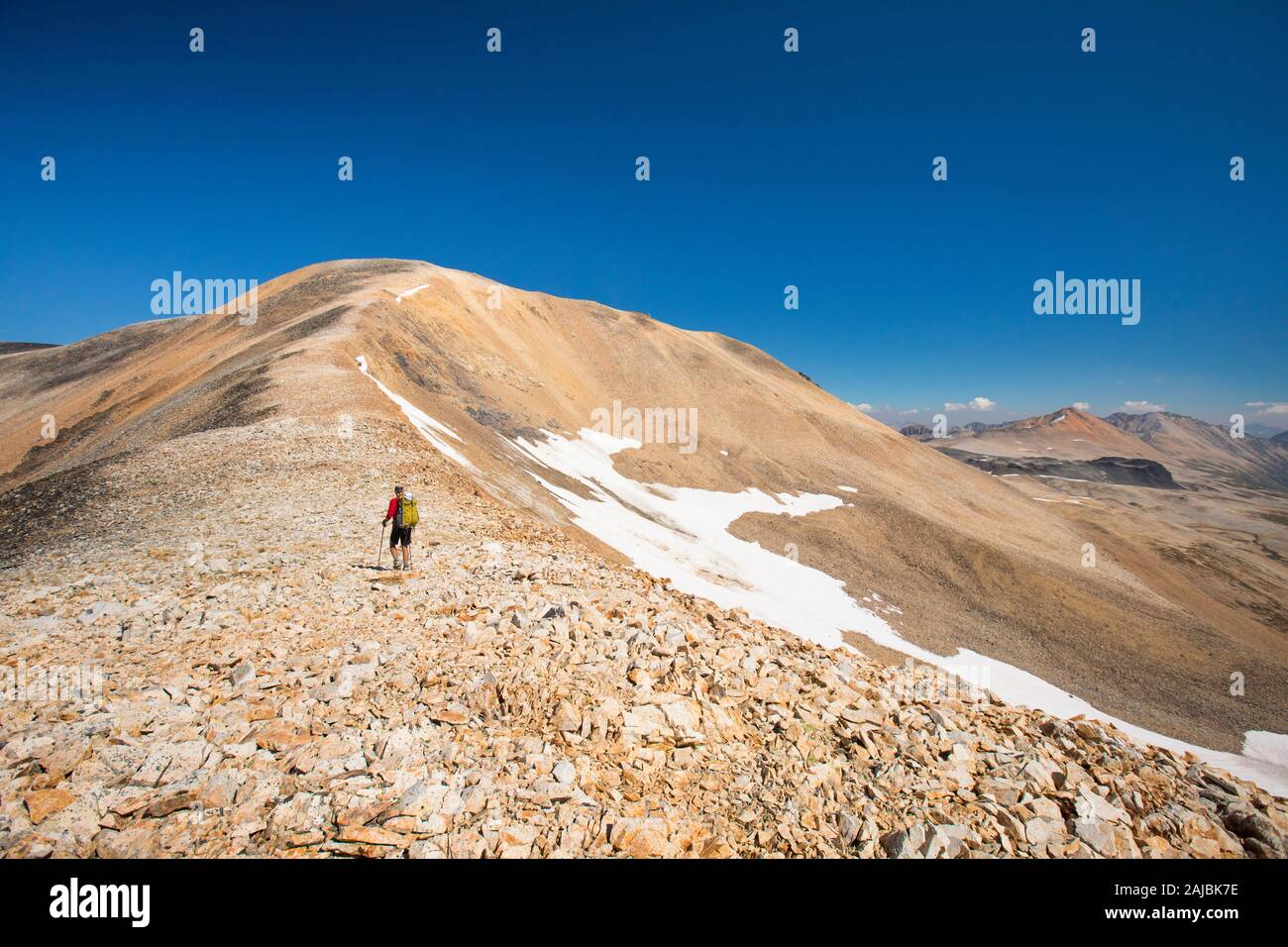 Hiking over endless rocky ridge in the mountains Stock Photo - Alamy