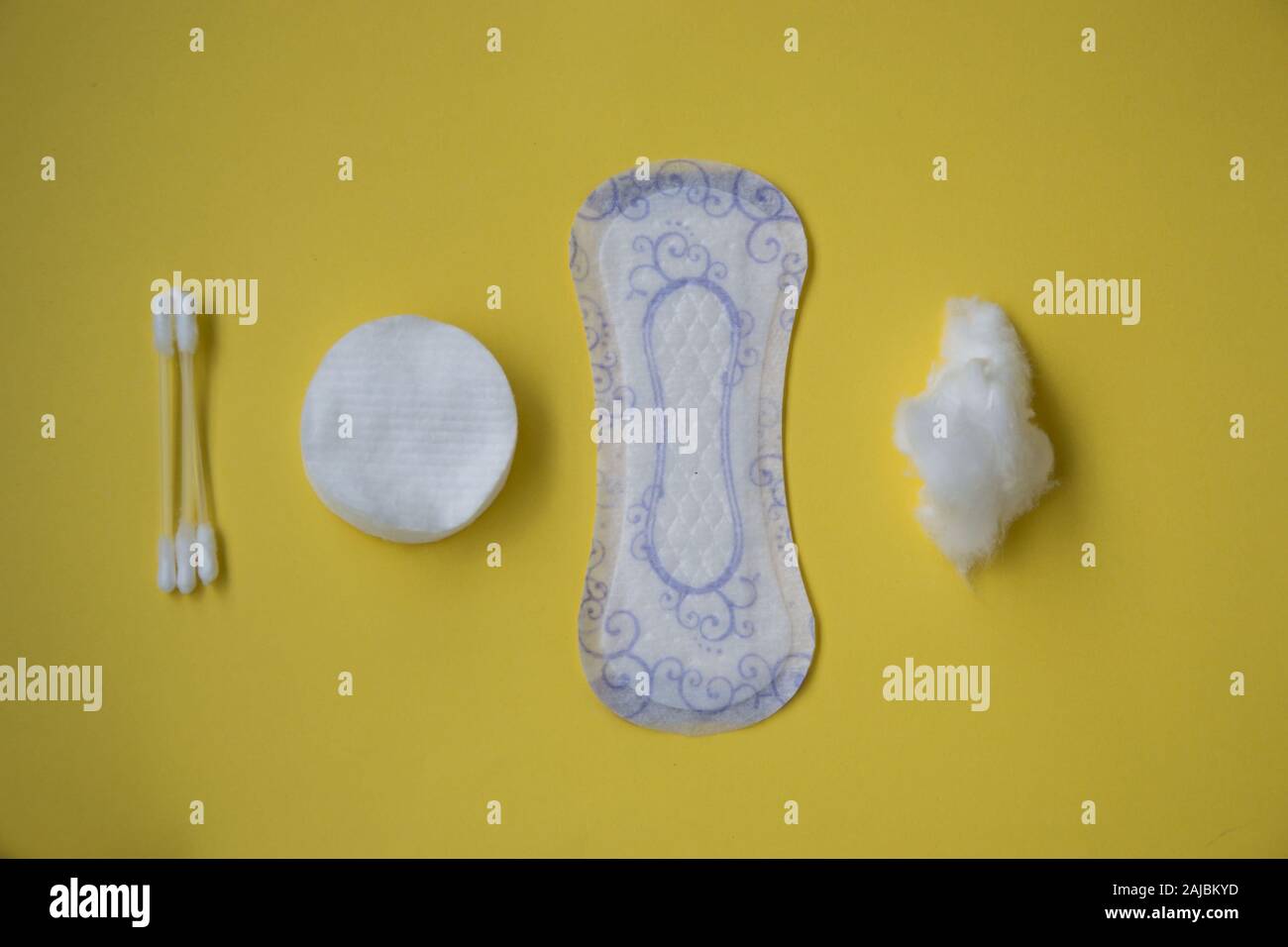 Floral clean sanitary pad on yellow background, cotton buds and pads ...