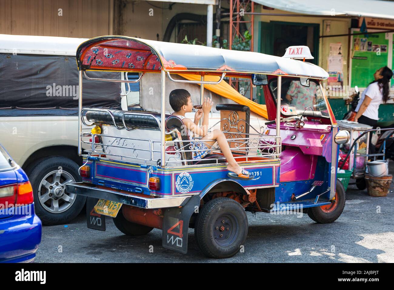 Bangkok, Thailand - December 09 2017: Boy in a taxi Tuk Tuk one of the ...