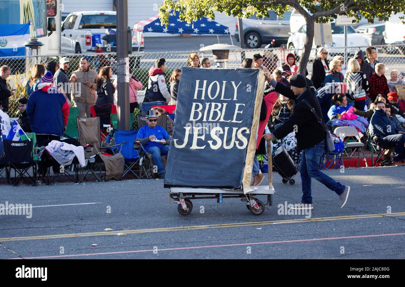 Man pushing large replica of bible on parade route hi-res stock ...