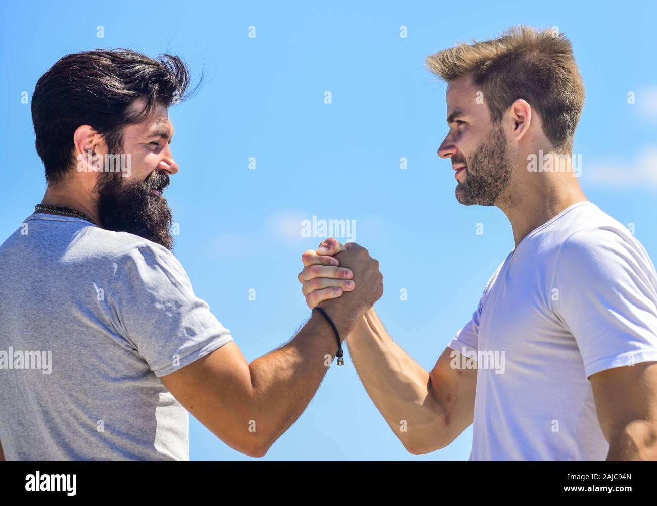 Handshake arm wrestling style. Strong and muscular arms. Successful ... Handshake arm wrestling style. Strong and muscular arms. Successful ...