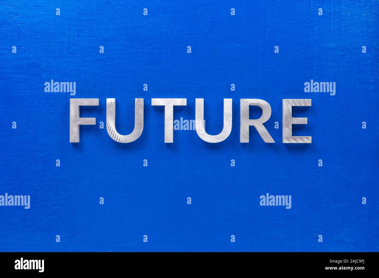 the word future laid with silver metal characters on blue board in flat ...