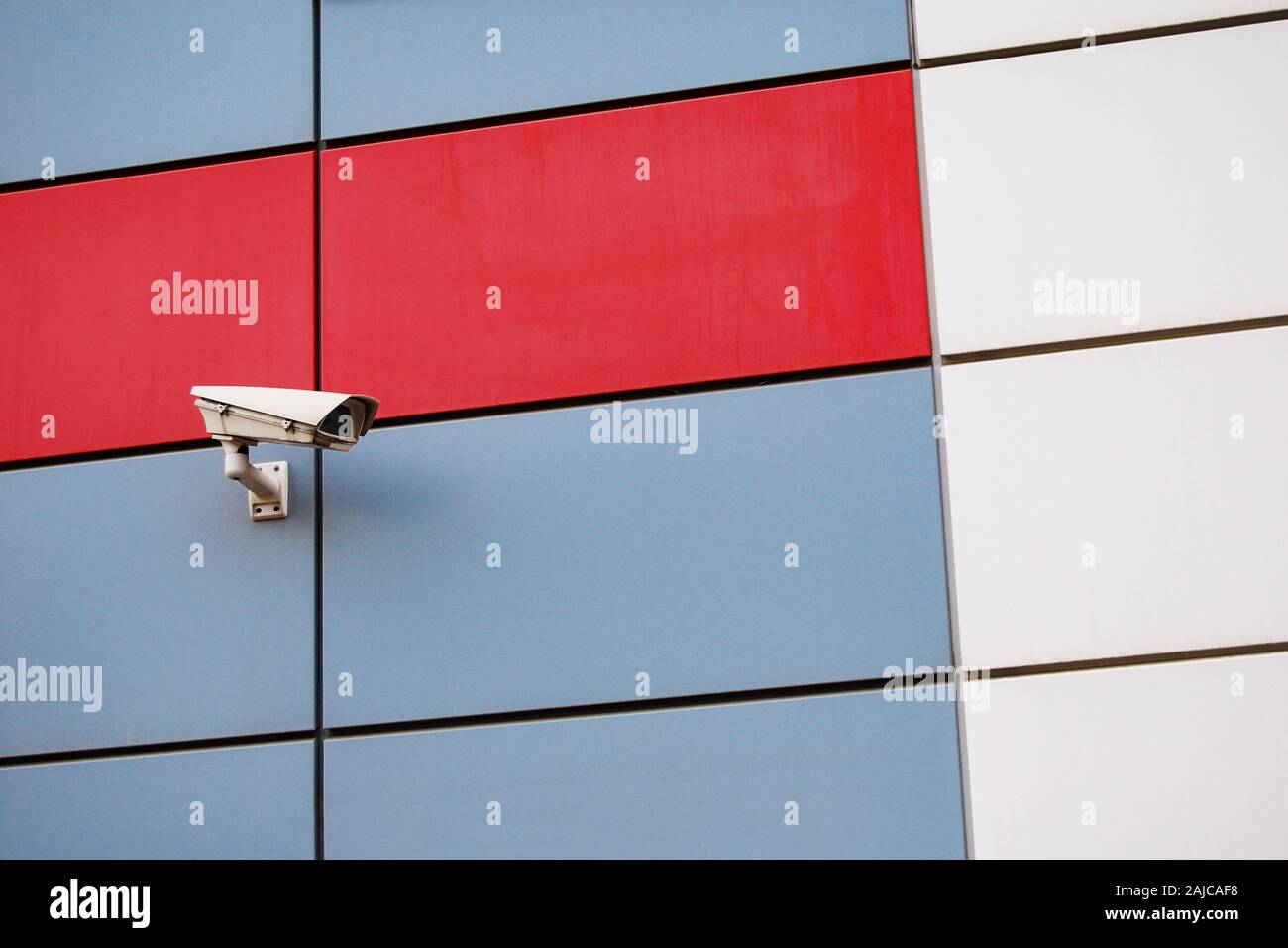 Outdoor surveillance camera on colored building facade Stock Photo - Alamy