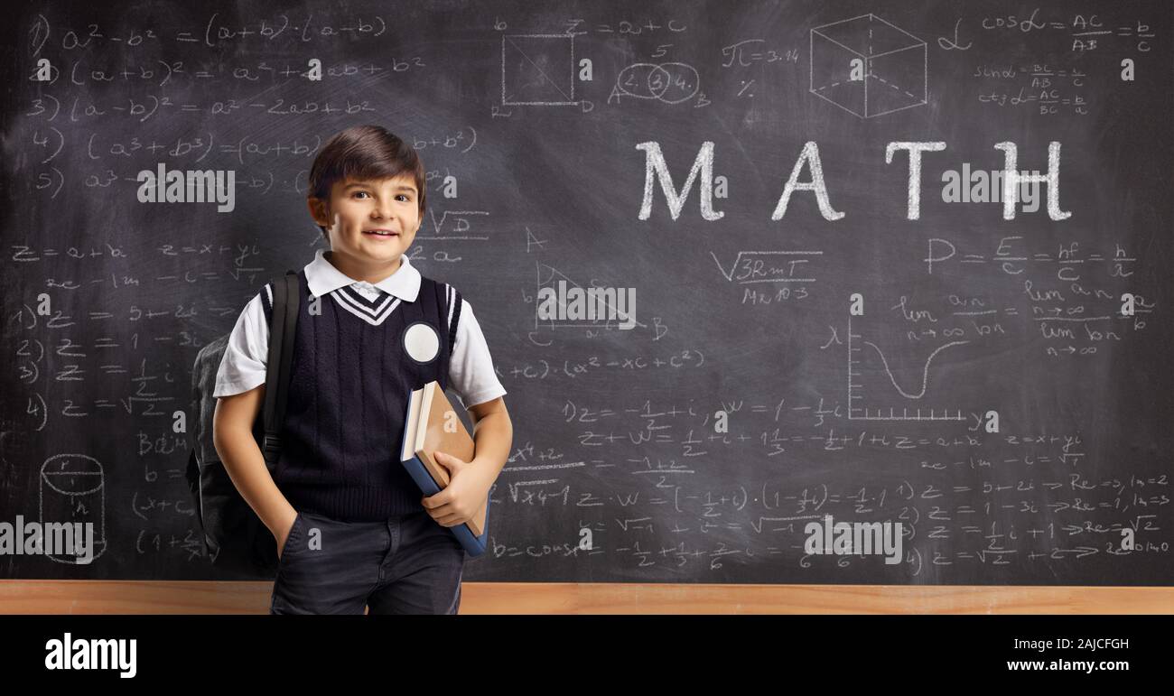 Schoolboy in front of a blackboard with math formulas isolated on white ...