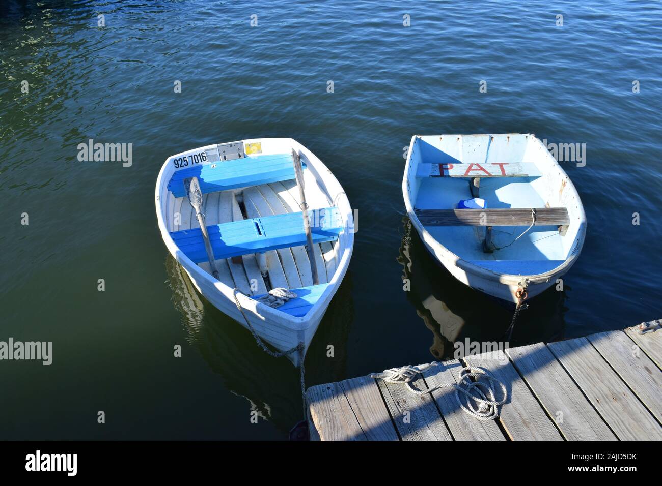 Two rowboats tied to a dock Stock Photo - Alamy