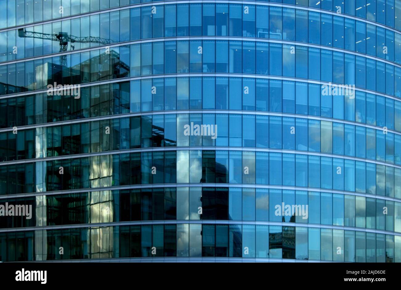 Corporate building windows with reflection of crane Stock Photo - Alamy