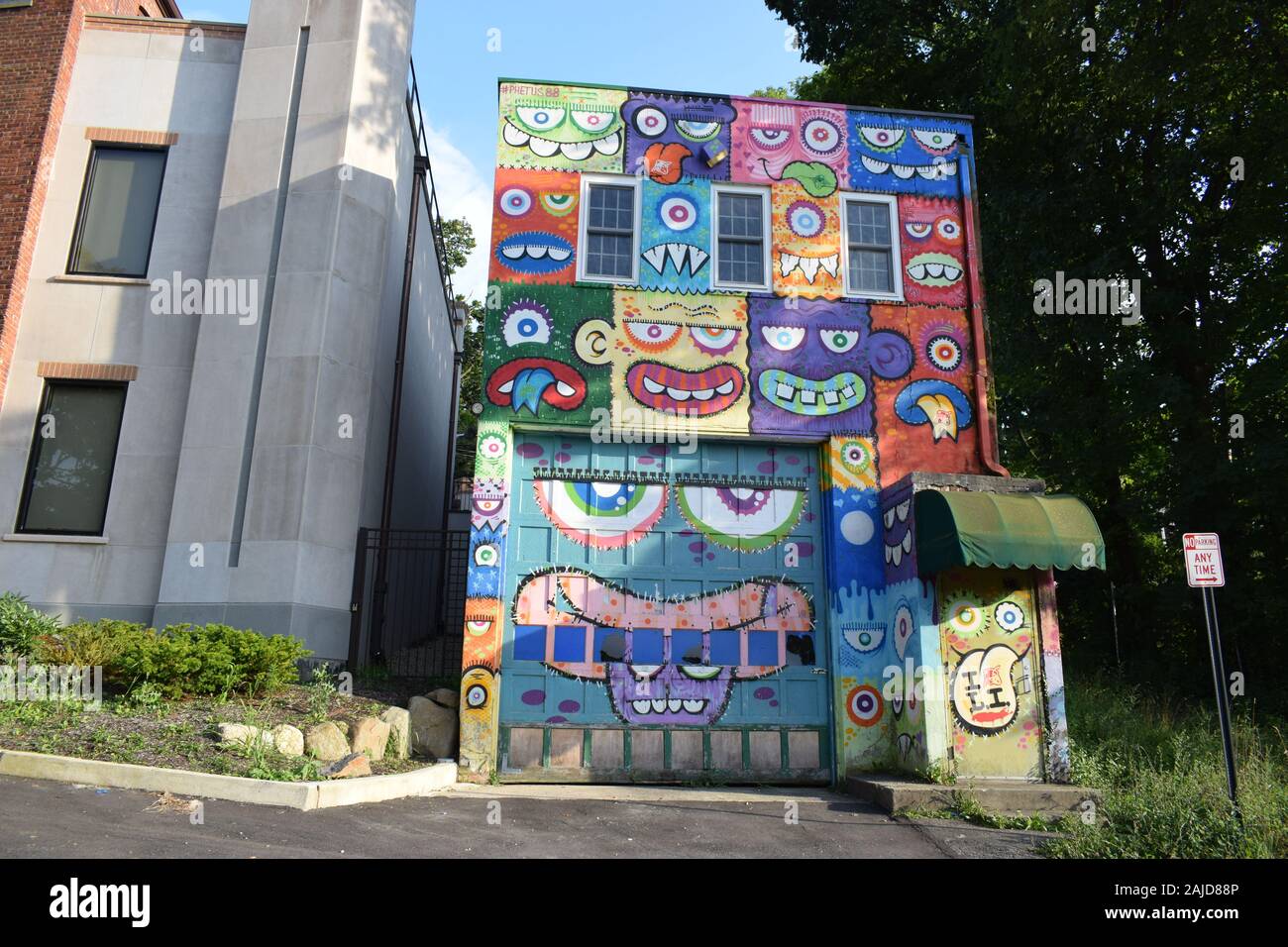 A colorful mural feauturing cute monster faces adorns a building Stock ...