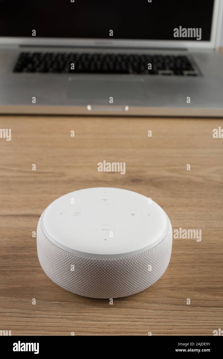 digital voice assistant on wooden table with computer Stock Photo - Alamy