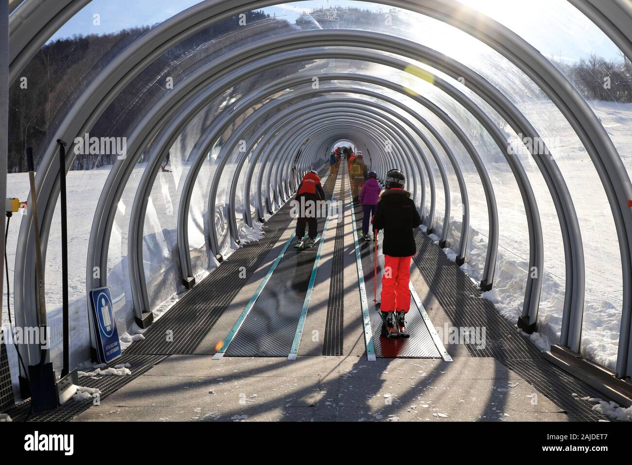 Skiers on a covered magic carpet on the learner's slope aka Bunny slope ...